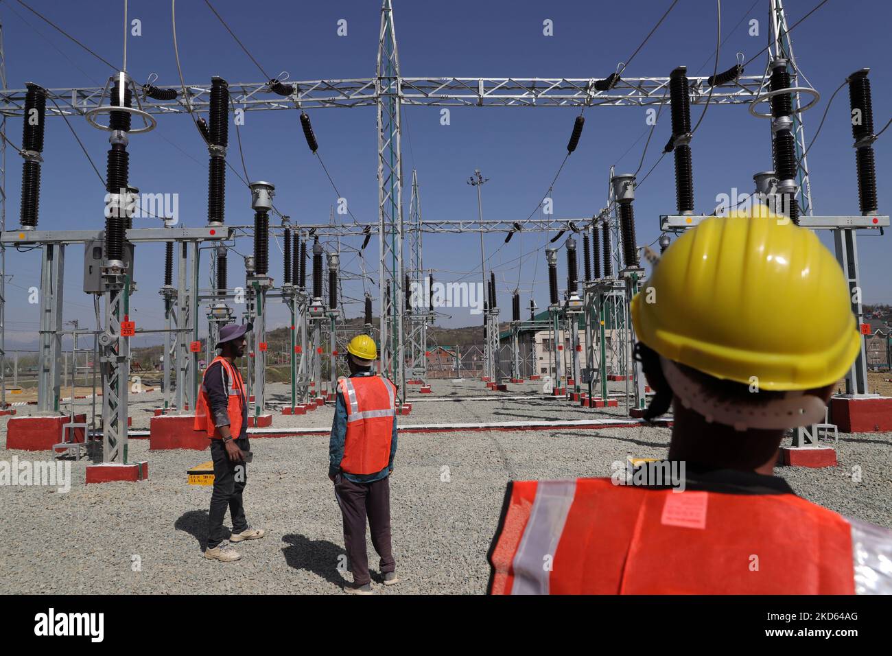 Workers are seen during Electric Train Run at Baramulla Railway Station ...