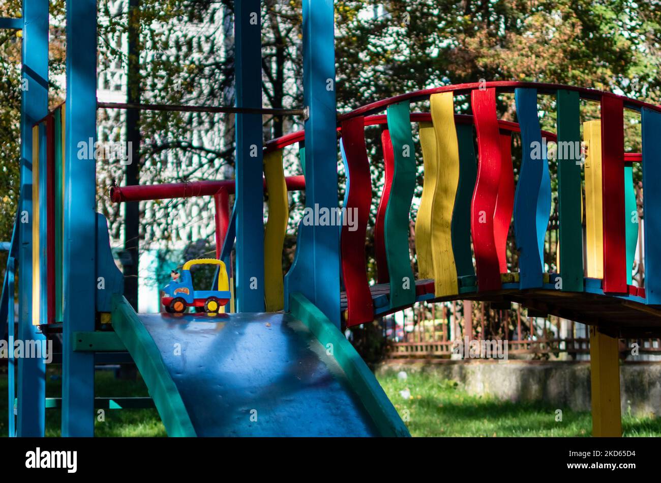 Bright multi-colored playground in courtyard of multi-storey buildings ...