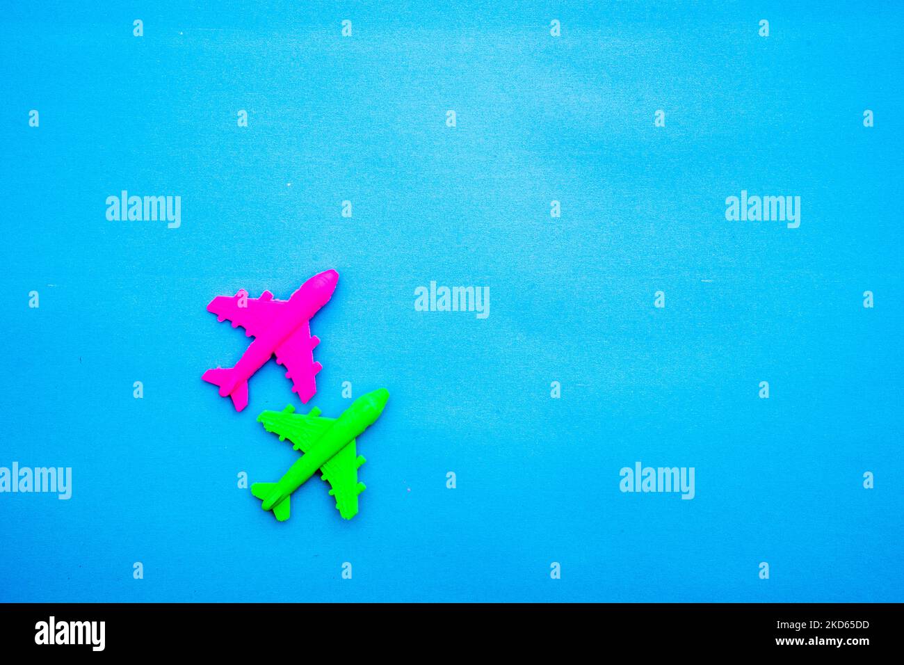 Flat lay of miniature toy airplane on blue background minimal trip and ...