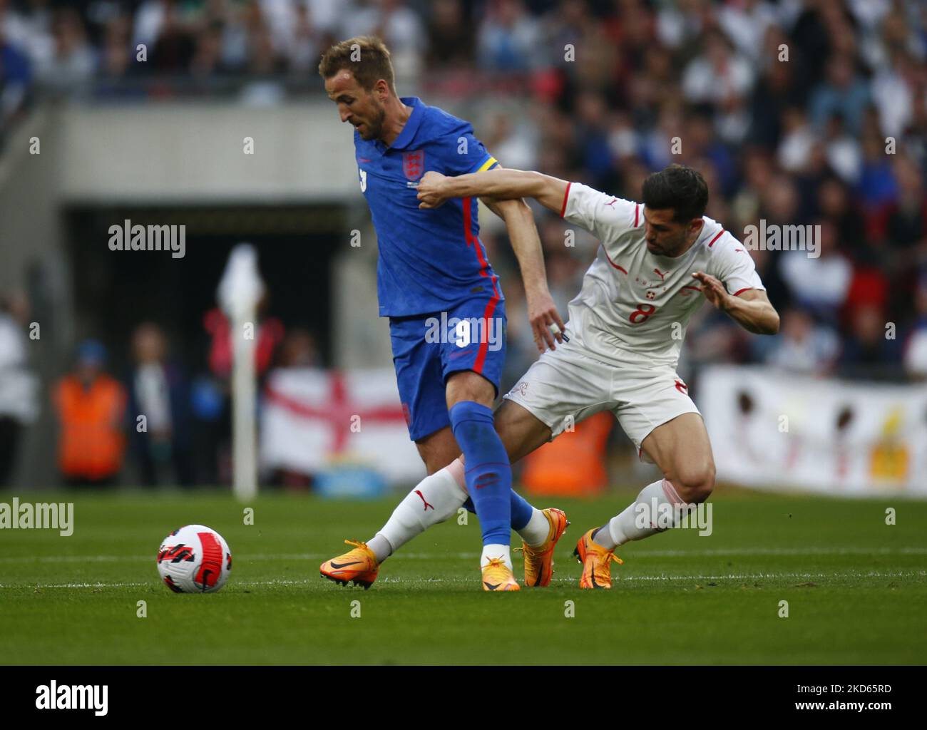 Harry Kane (Tottenham) of England holds of Remo Freuler (Atalanta) of ...