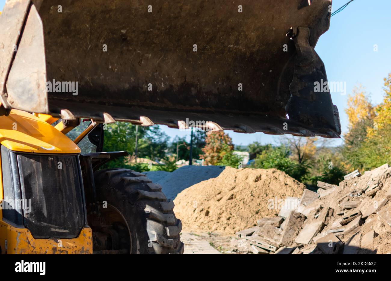 Excavator bucket close-up on blurred background of construction site ...