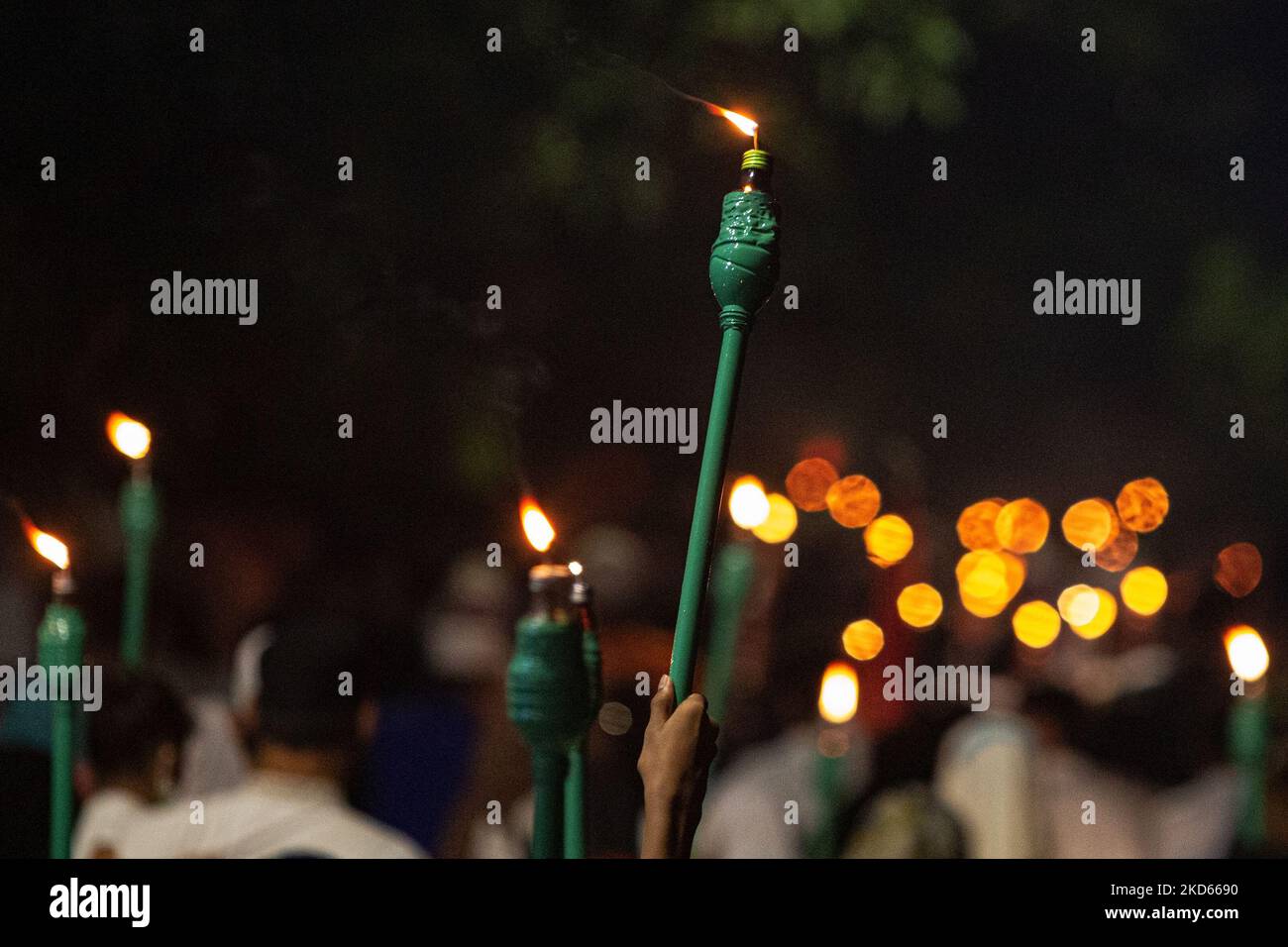 Indonesian muslims hold torches during a torch parade to welcome the ...