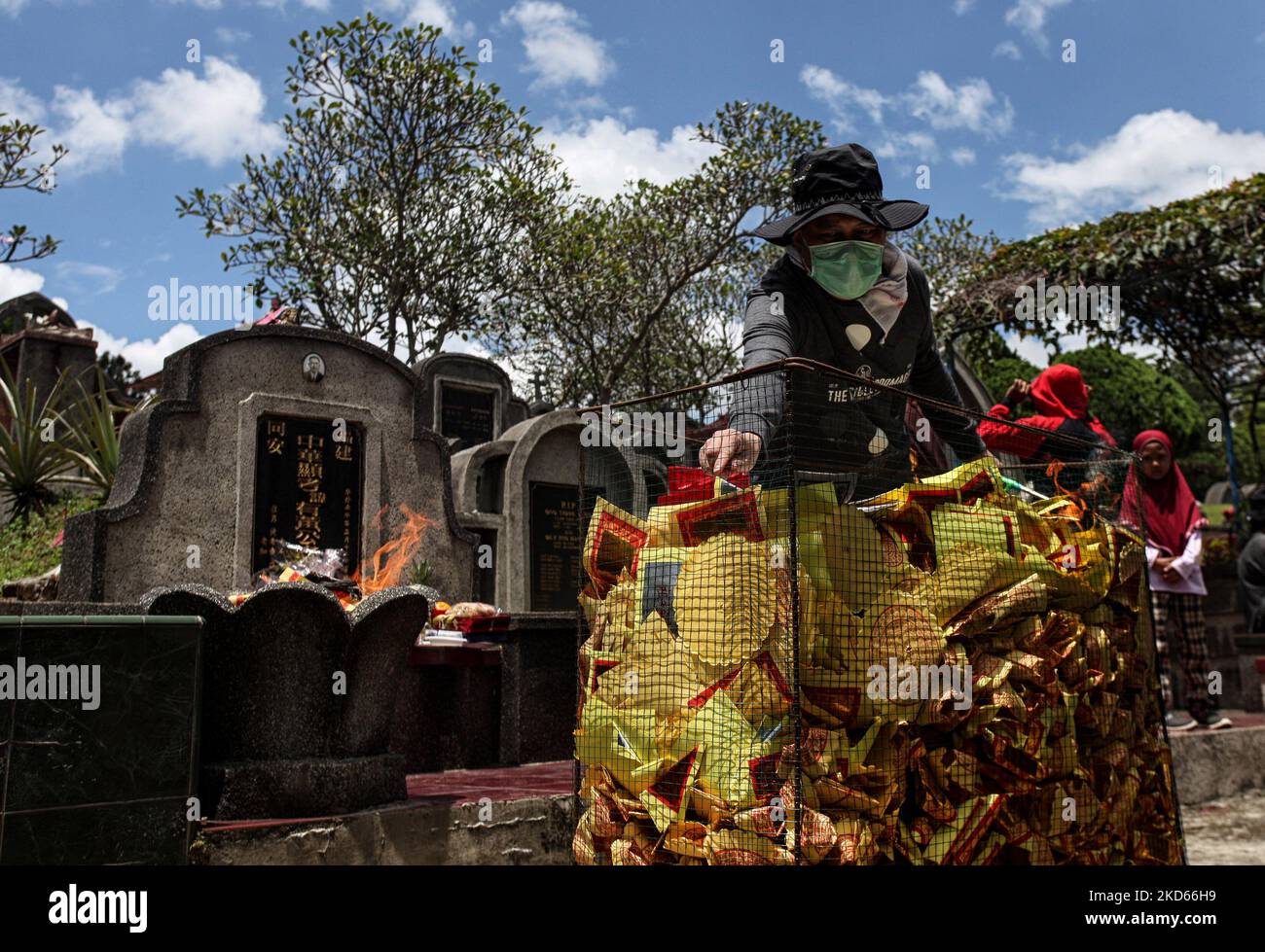 A man prepare offerings during the Qingming festival, also known as ...