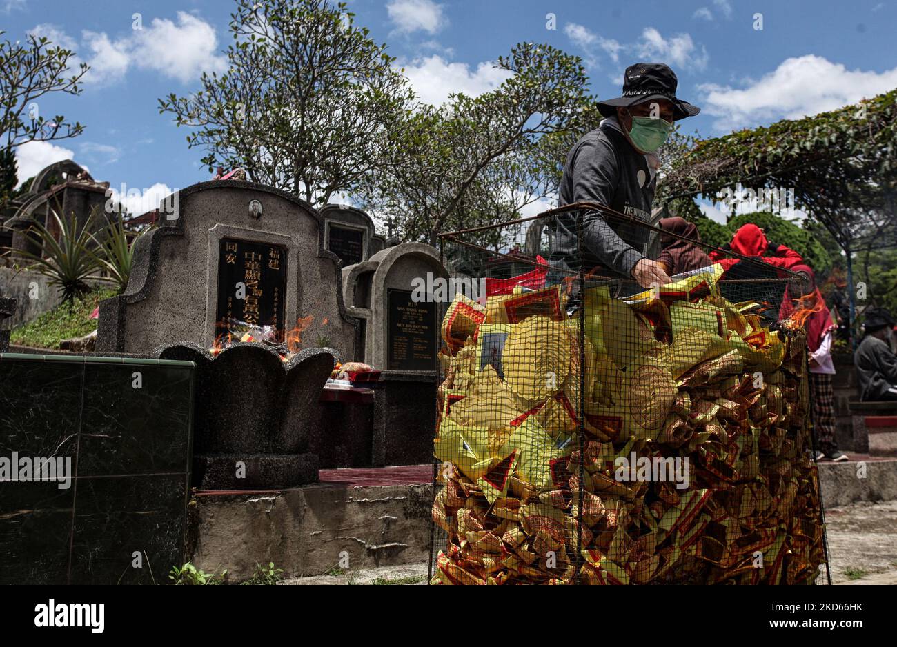 A man prepare offerings during the Qingming festival, also known as ...