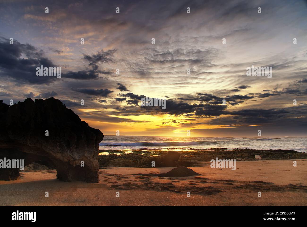 A mesmerizing sunset over the beautiful coast Stock Photo - Alamy