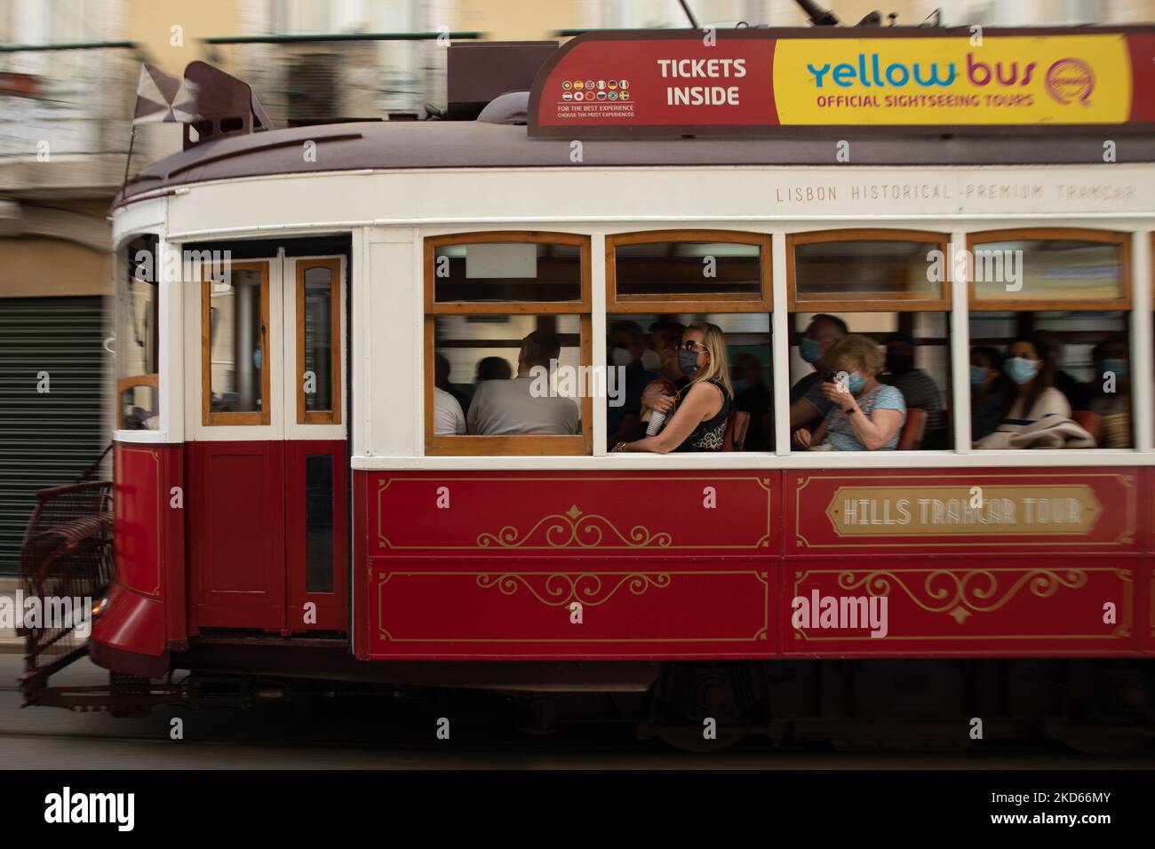 People wearing a protective mask inside a typical tram of Lisbon, on ...