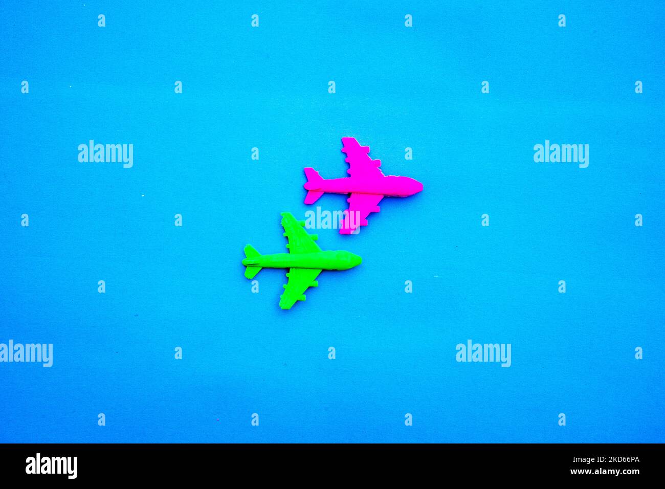 Flat lay of miniature toy airplane on blue background minimal trip and ...