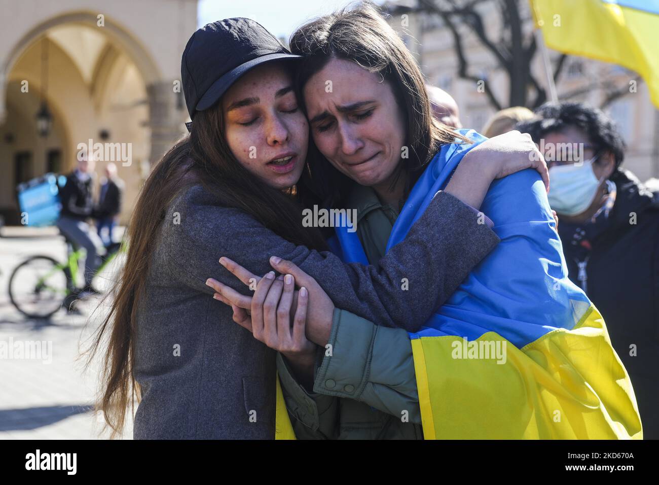 Two Young Women Embrace While Attending A Demonstration Of Solidarity
