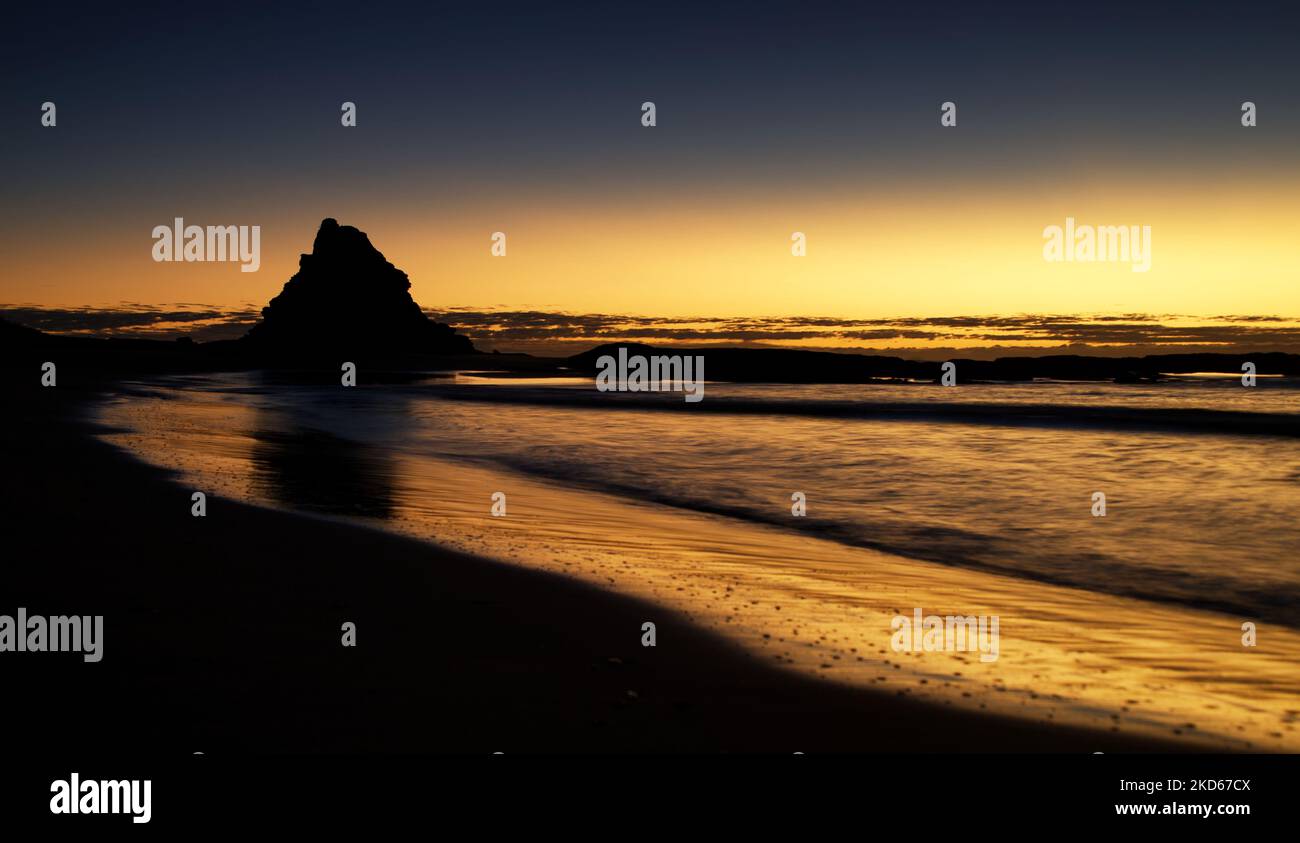 A mesmerizing sunset over the beautiful coast Stock Photo - Alamy