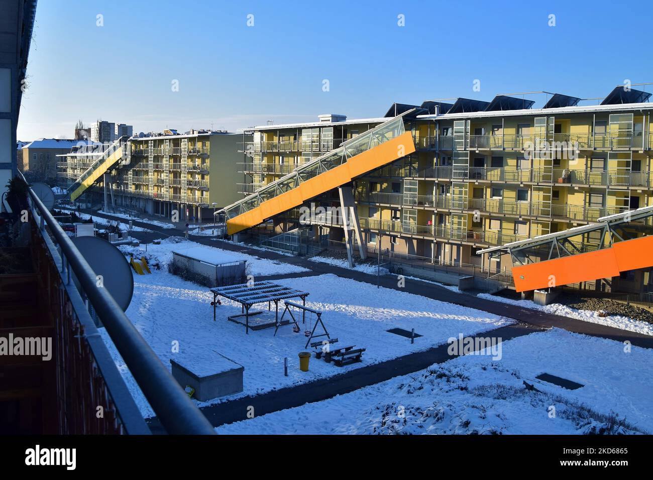 A beautiful balcony view of modern buildings and the park in winter ...