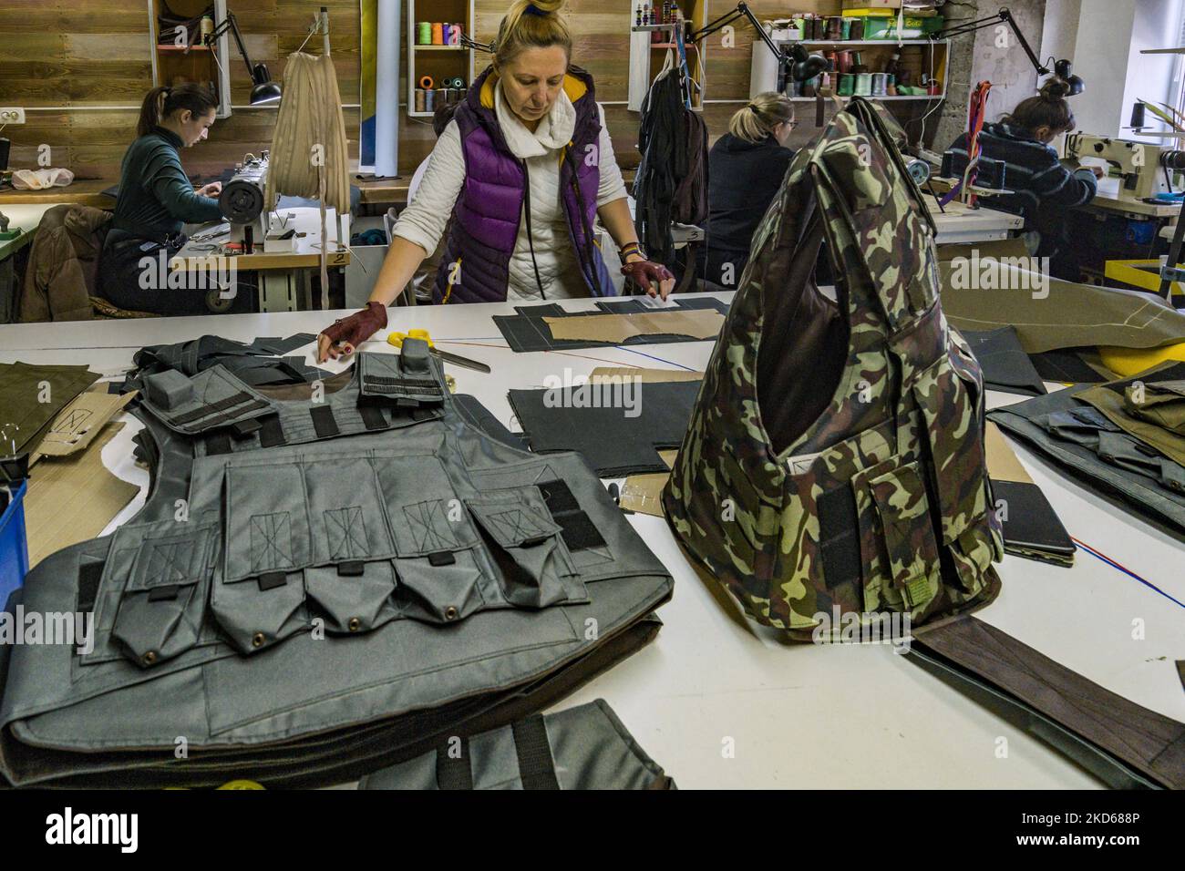 A woman prepares the textil patterns to make vests for the soldiers of ...
