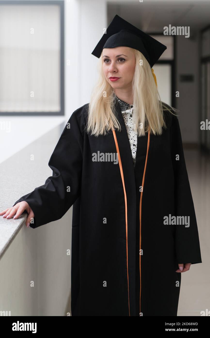 Young Happy Woman University Graduates in Graduation Gown and Cap to ...