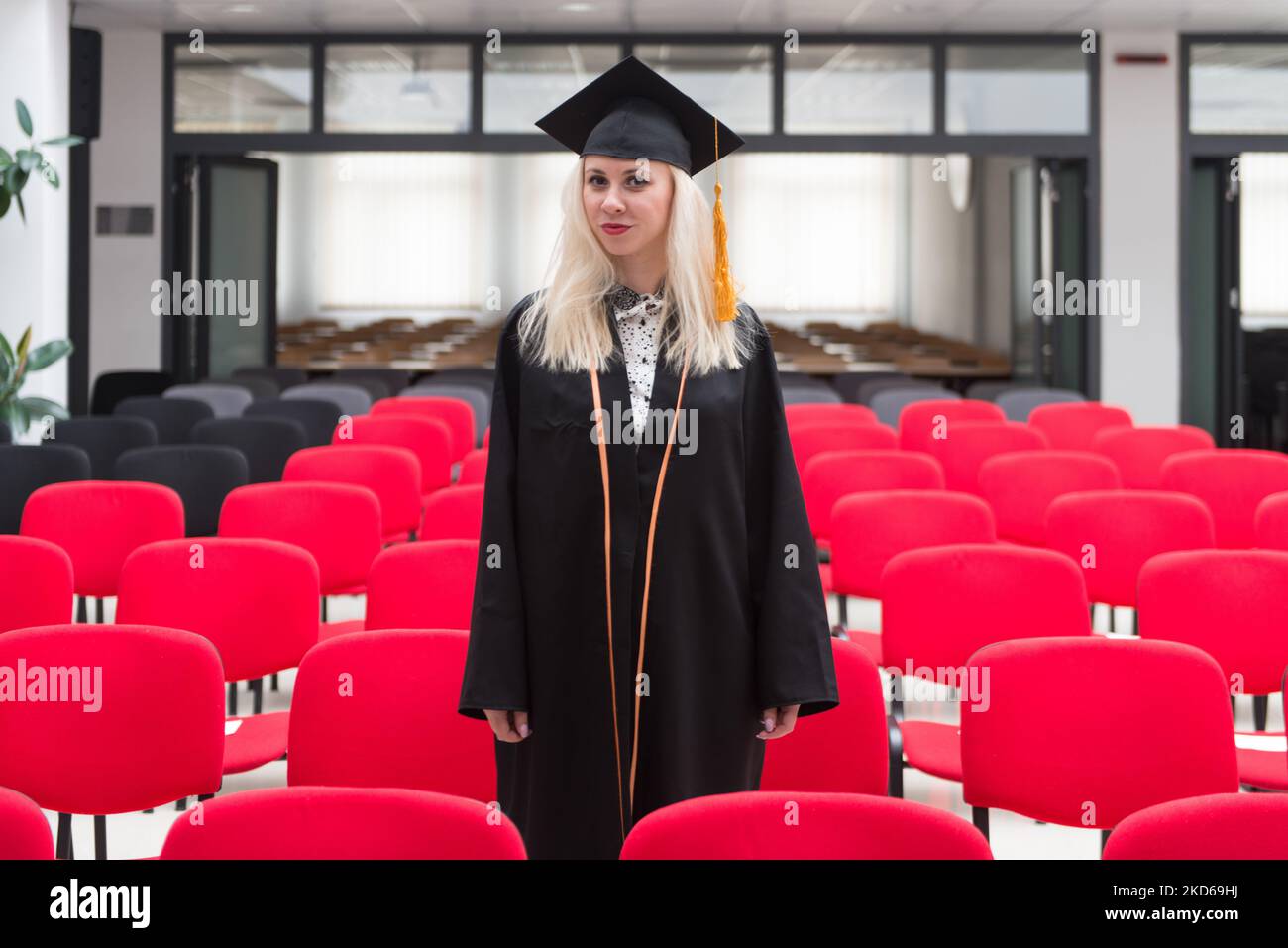 Young Happy Woman University Graduates in Graduation Gown and Cap to ...