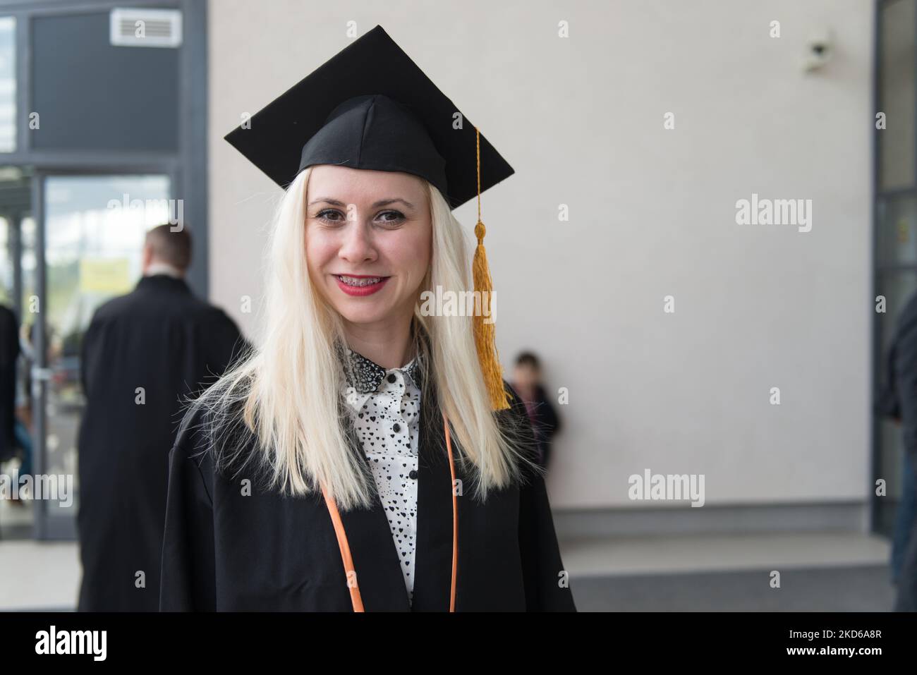Female Blonde College or High School Graduate Confidently Wearing Black ...