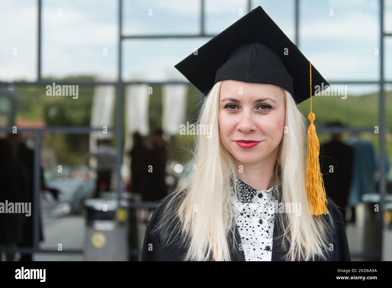 Young Happy Woman University Graduates in Graduation Gown and Cap Holds ...