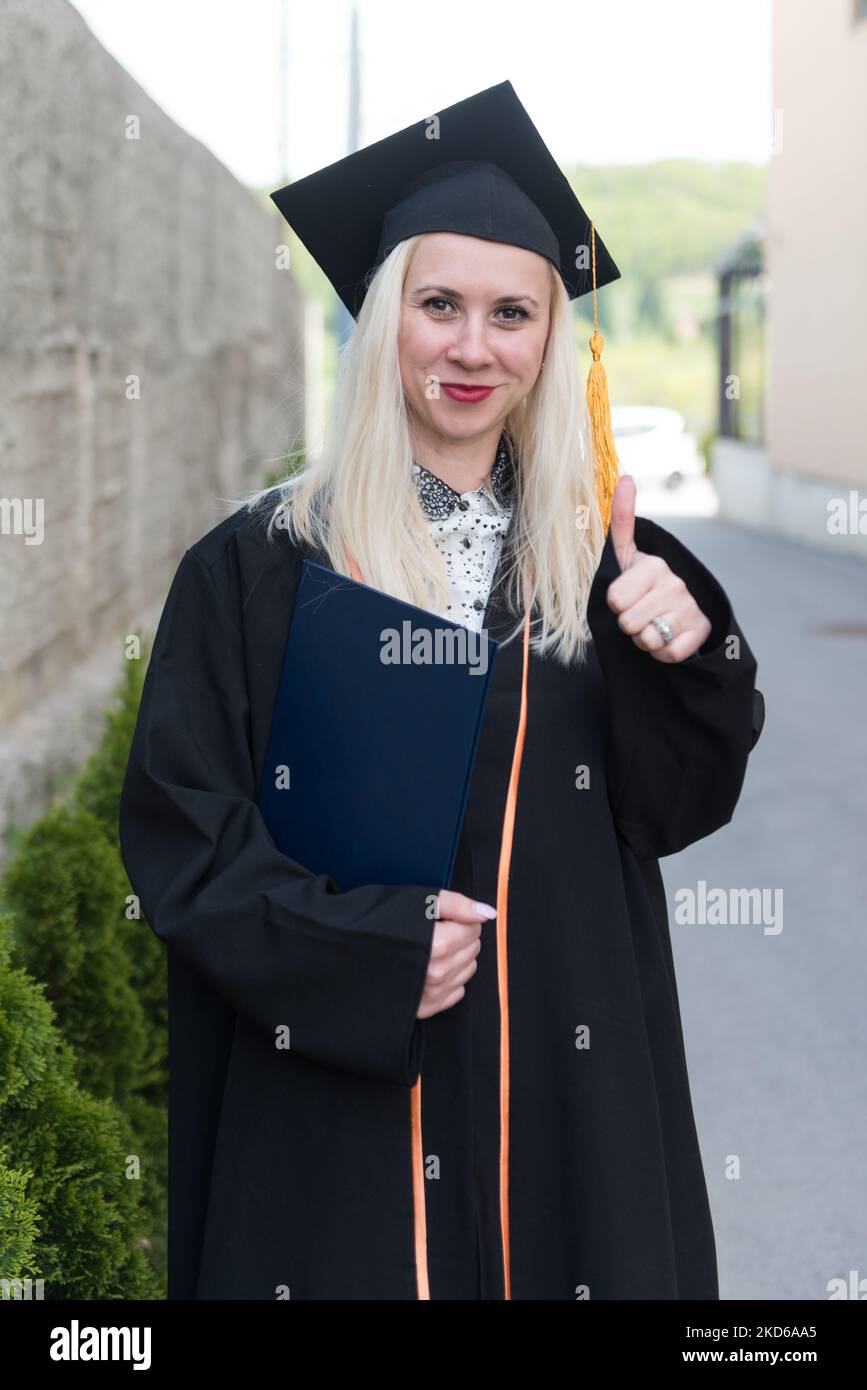 Female Blonde College or High School Graduate Confidently Wearing Black ...