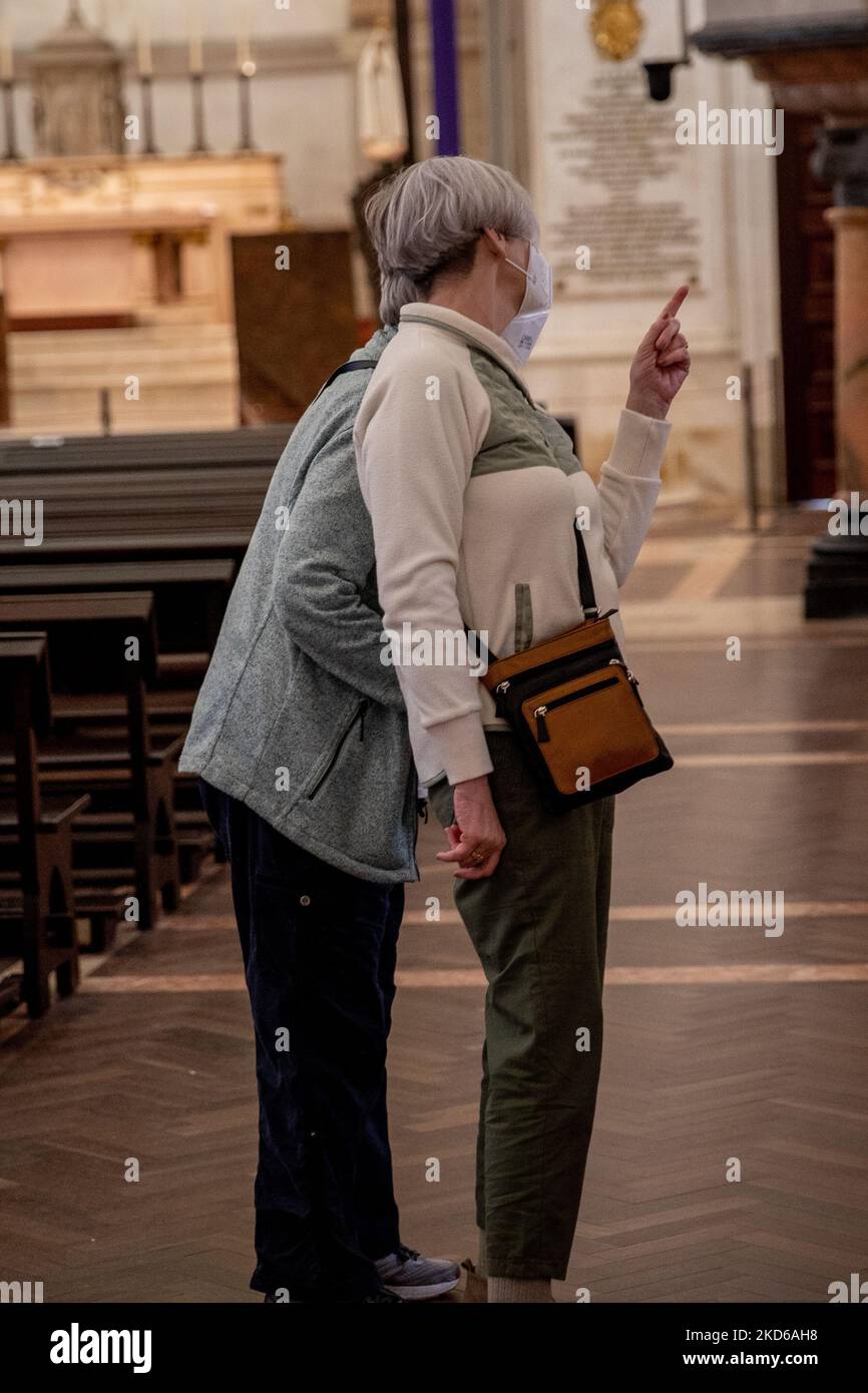 People wearing a protective face mark walk inside the Sanctuary of Our ...