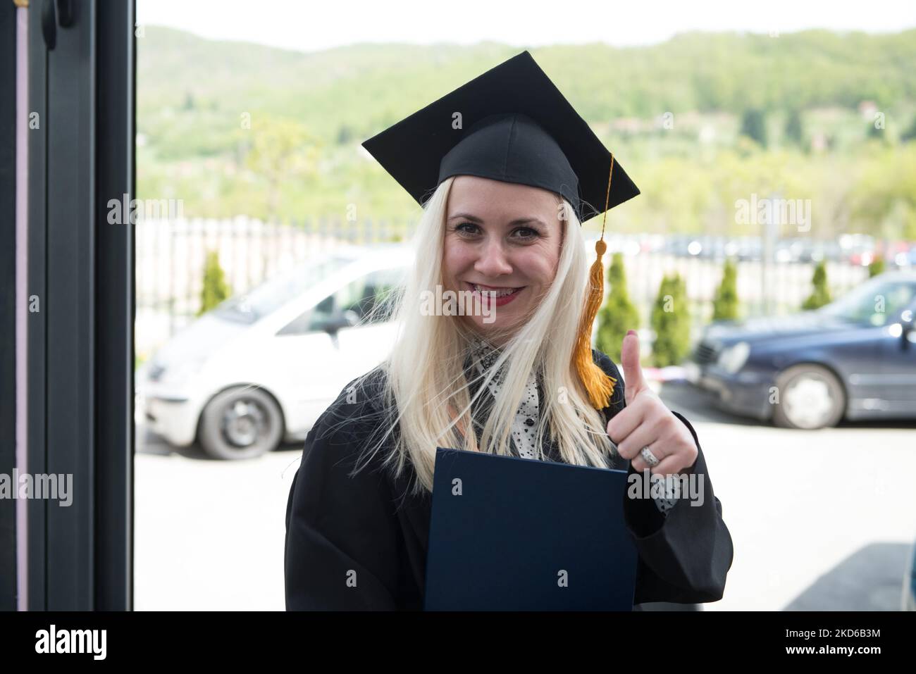 Happy Cute Blonde Caucasian Grad Girl is Smiling - She is in a Black ...
