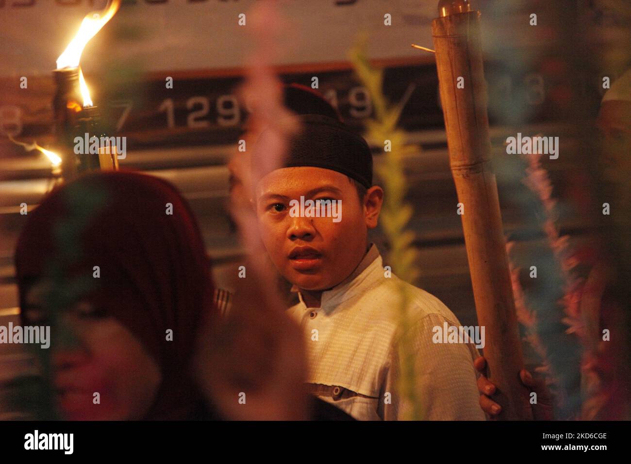 Indonesian muslims take a part in the torch parade to welcoming the ...