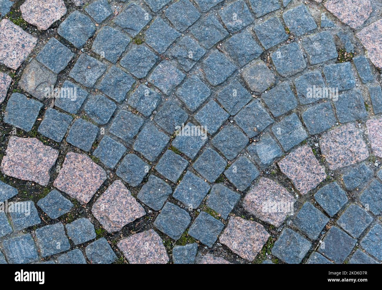 Bicolor stone cobblestone granite of walking street. View from above ...
