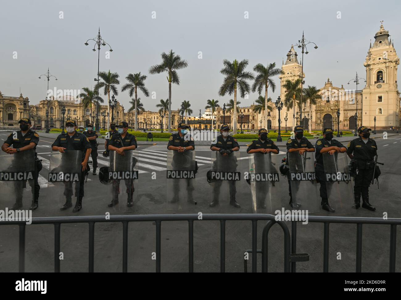 Police officers block the entrance to Plaza De Armas as members of the ...