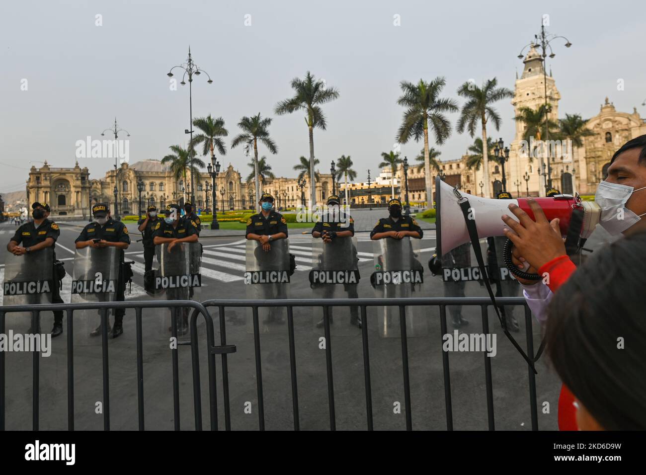 Police officers block the entrance to Plaza De Armas as members of the ...