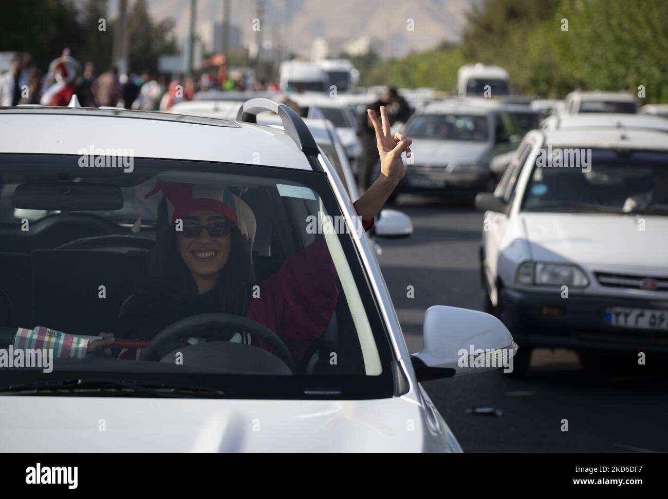 An Iranian soccer female fan flashes a Victory sign as she arrives the ...