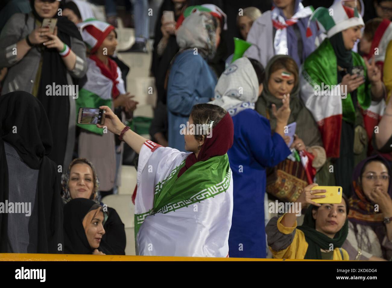 An Iranian soccer female fan wearing an Iran flag takes a selfie as she ...