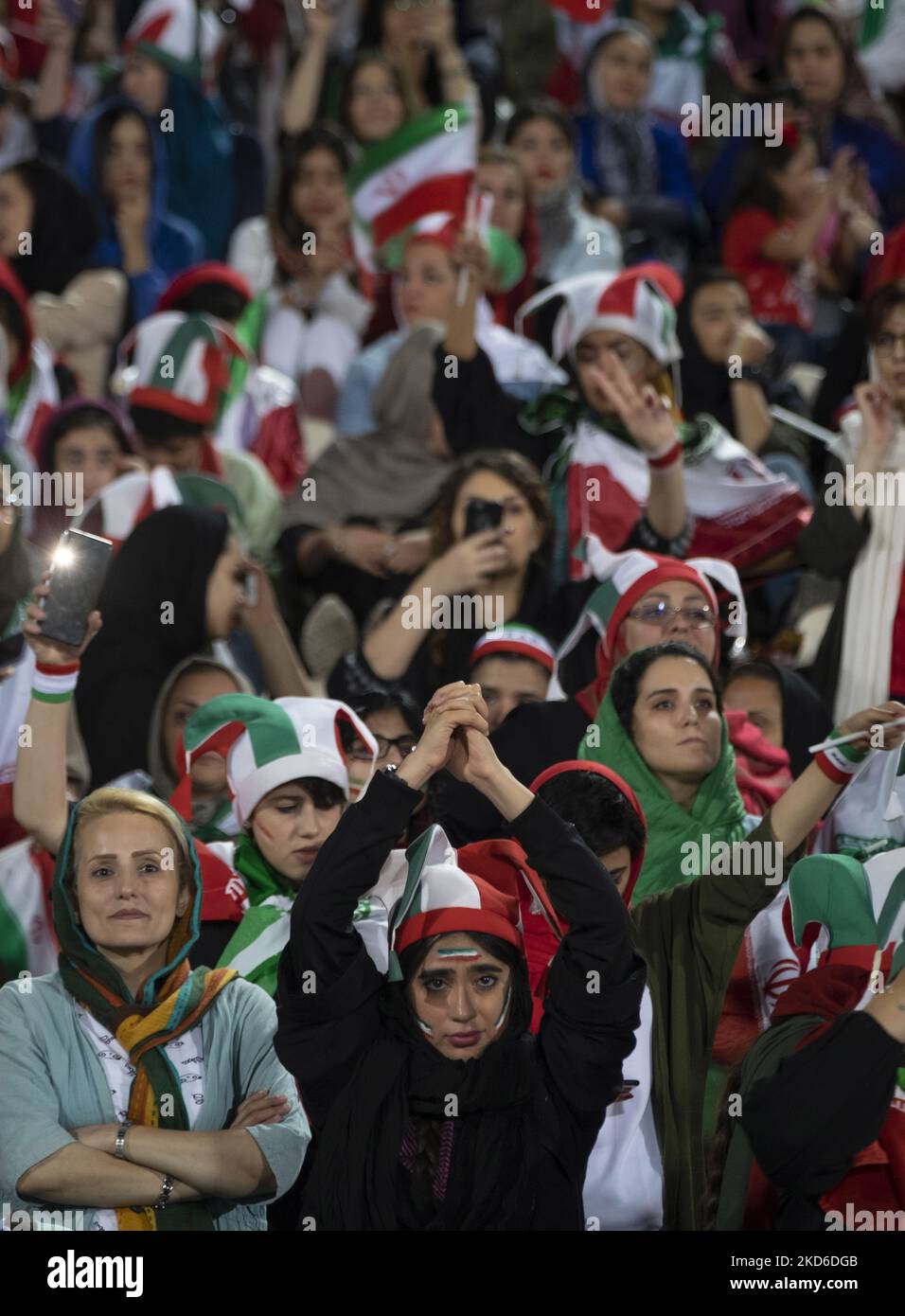 An Iranian soccer female fan holds-up her hands as a sign of unity ...