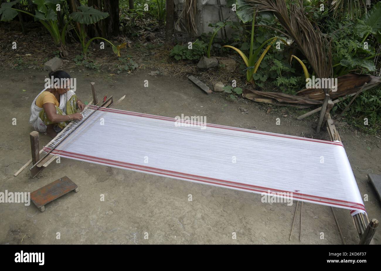 An Assamese woman weaves Assamese Traditional Gamosa (scarf) in ...