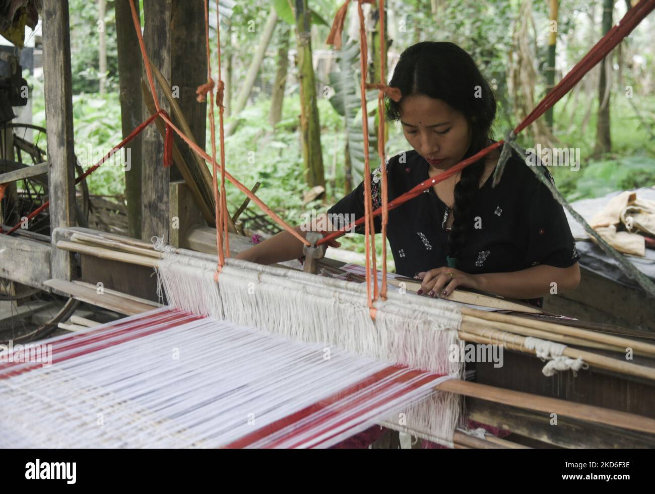 An Assamese woman weaves Assamese Traditional Gamosa (scarf) in ...