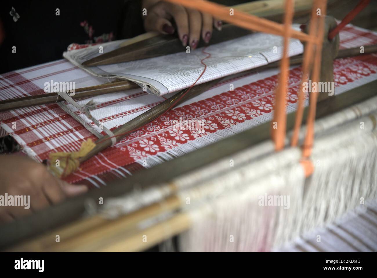 An Assamese woman weaves Assamese Traditional Gamosa (scarf) in ...