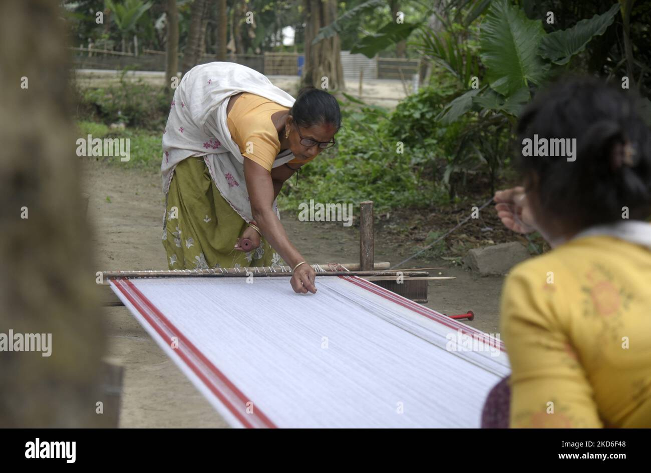 An Assamese woman weaves Assamese Traditional Gamosa (scarf) in ...