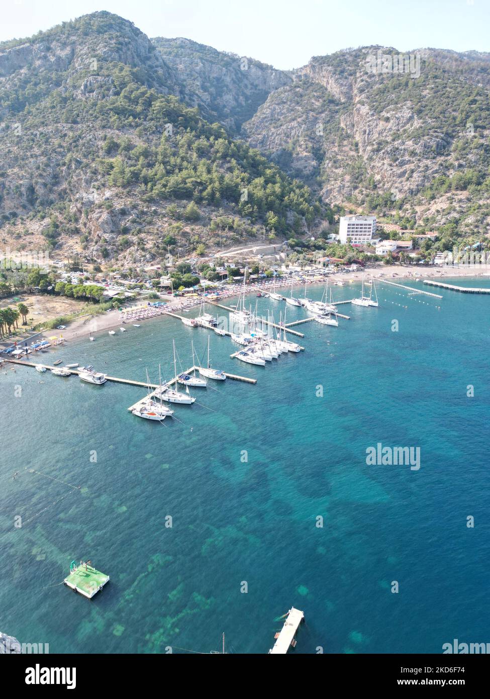 An aerial shot of a port with many docked boats in the beautiful sea ...