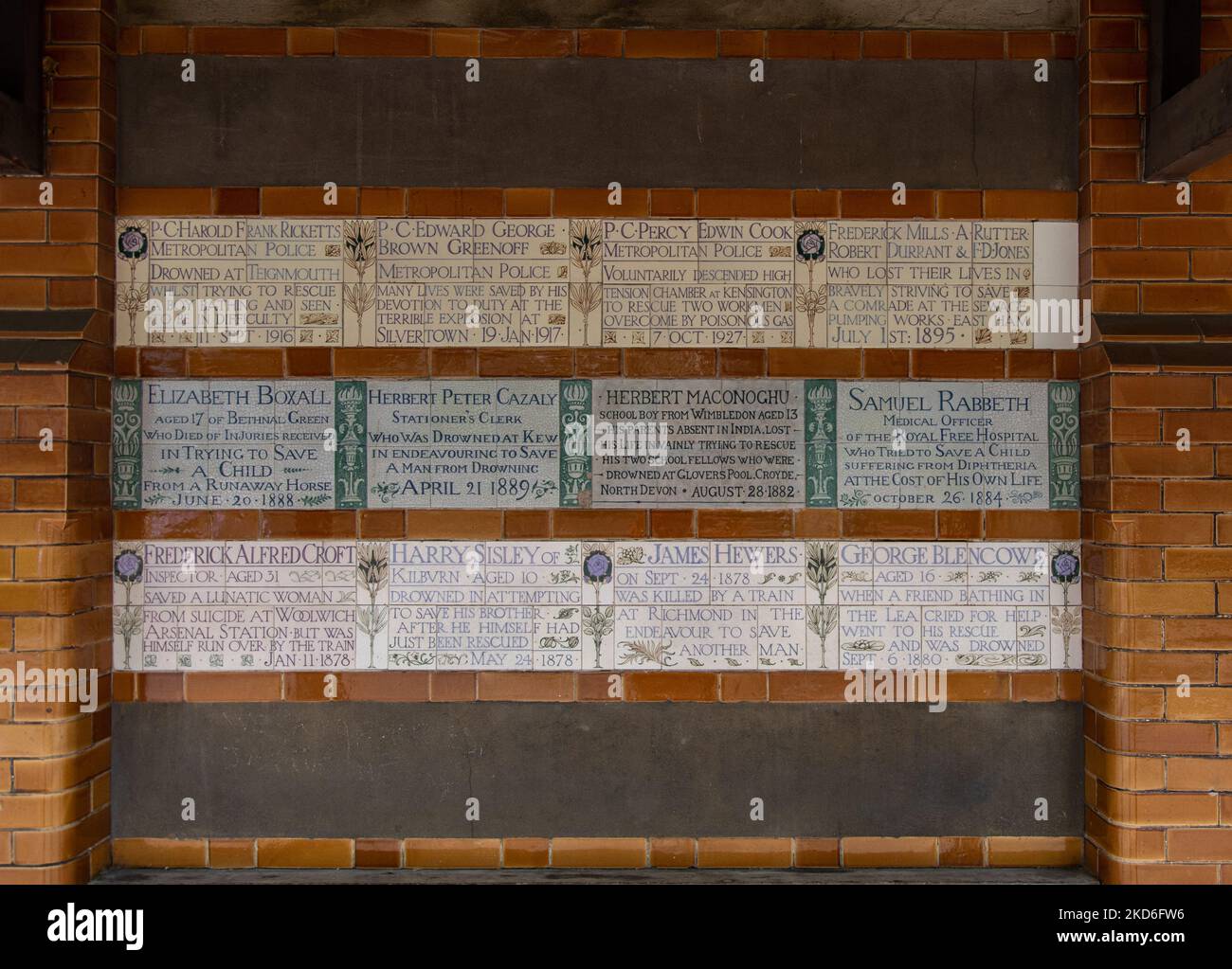 A closeup of information plaques of the Watts Memorial in Postman's Park in London, England ...