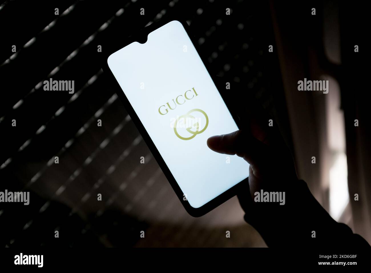 In this photo illustration a Gucci logo seen displayed on a smartphone ...