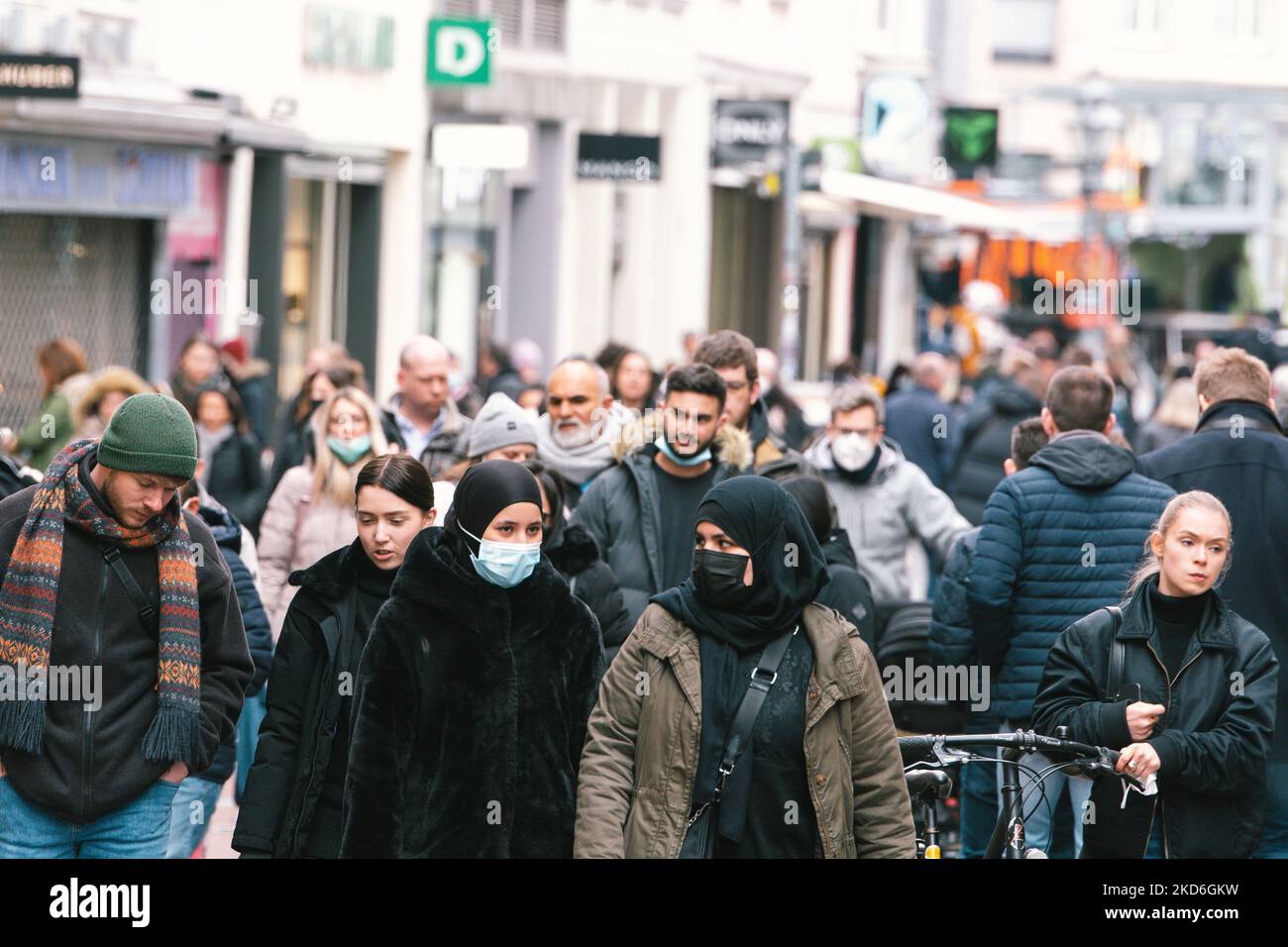 shoppers are seen, some with masks and some without masks in city ...