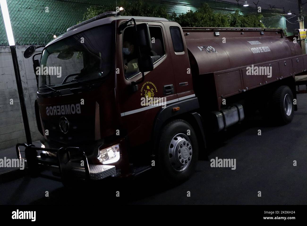Firefighters attend to a fire in a solvent factory in the Granjas ...