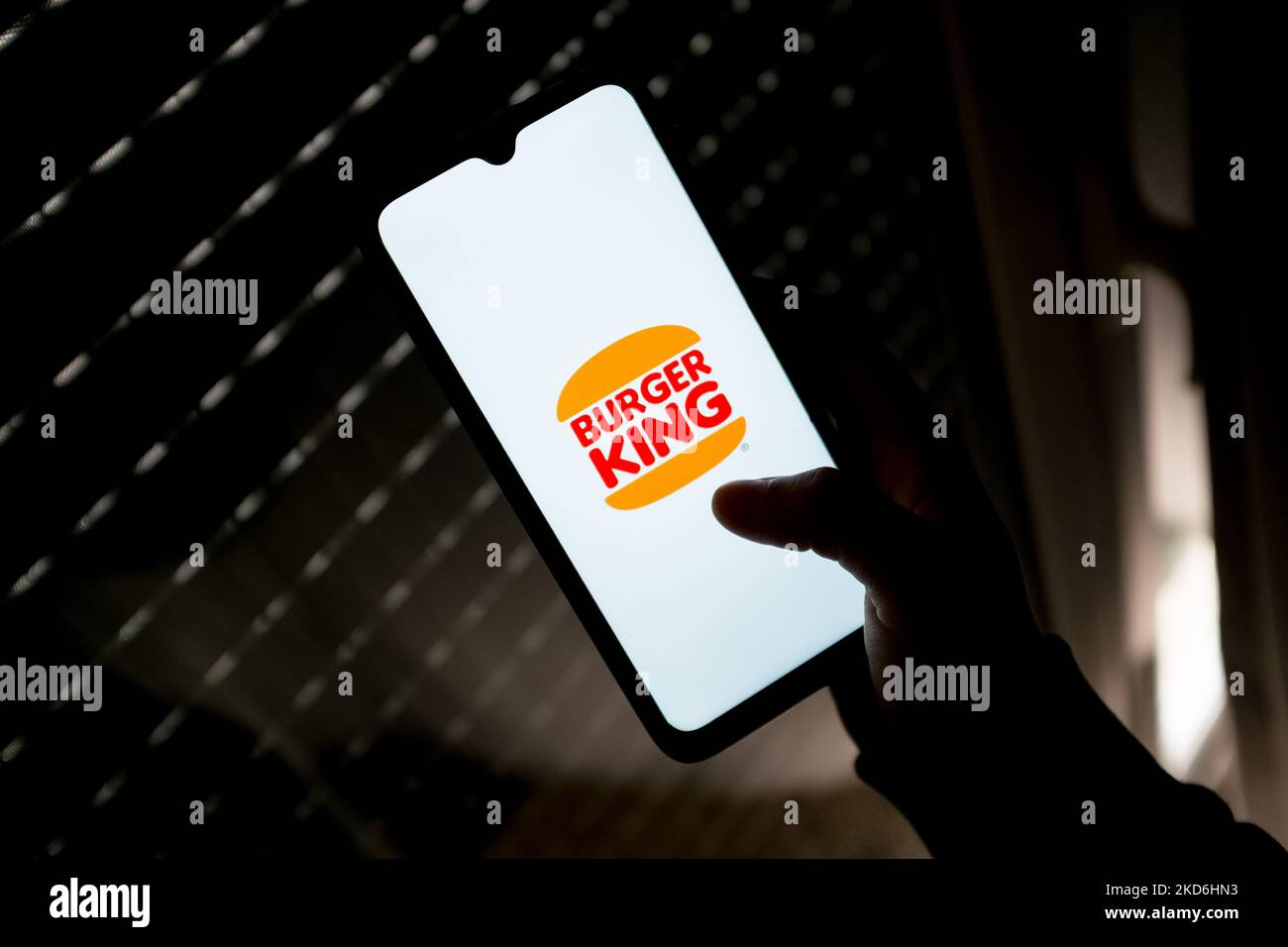 In this photo illustration a Burger King logo seen displayed on a ...