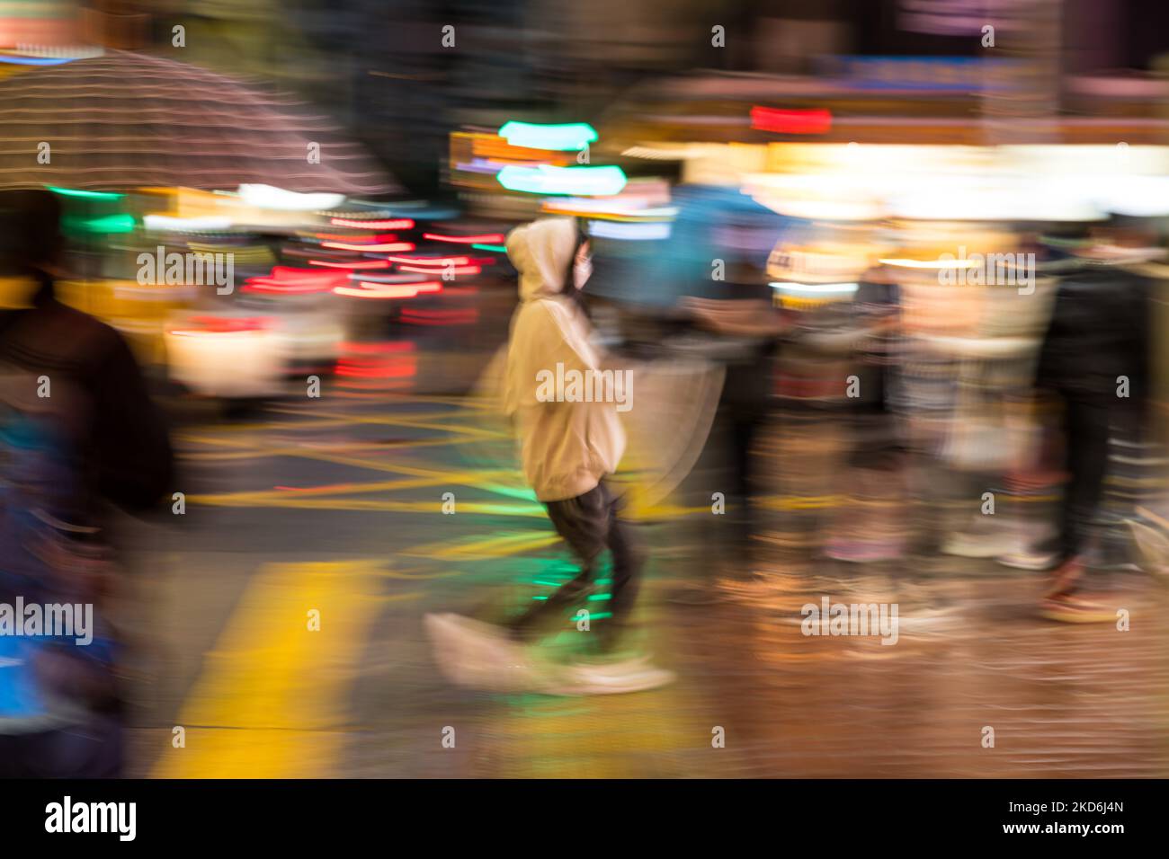 Hong Kong, China, 2 Apr 2022, A young lady runs across a street in ...
