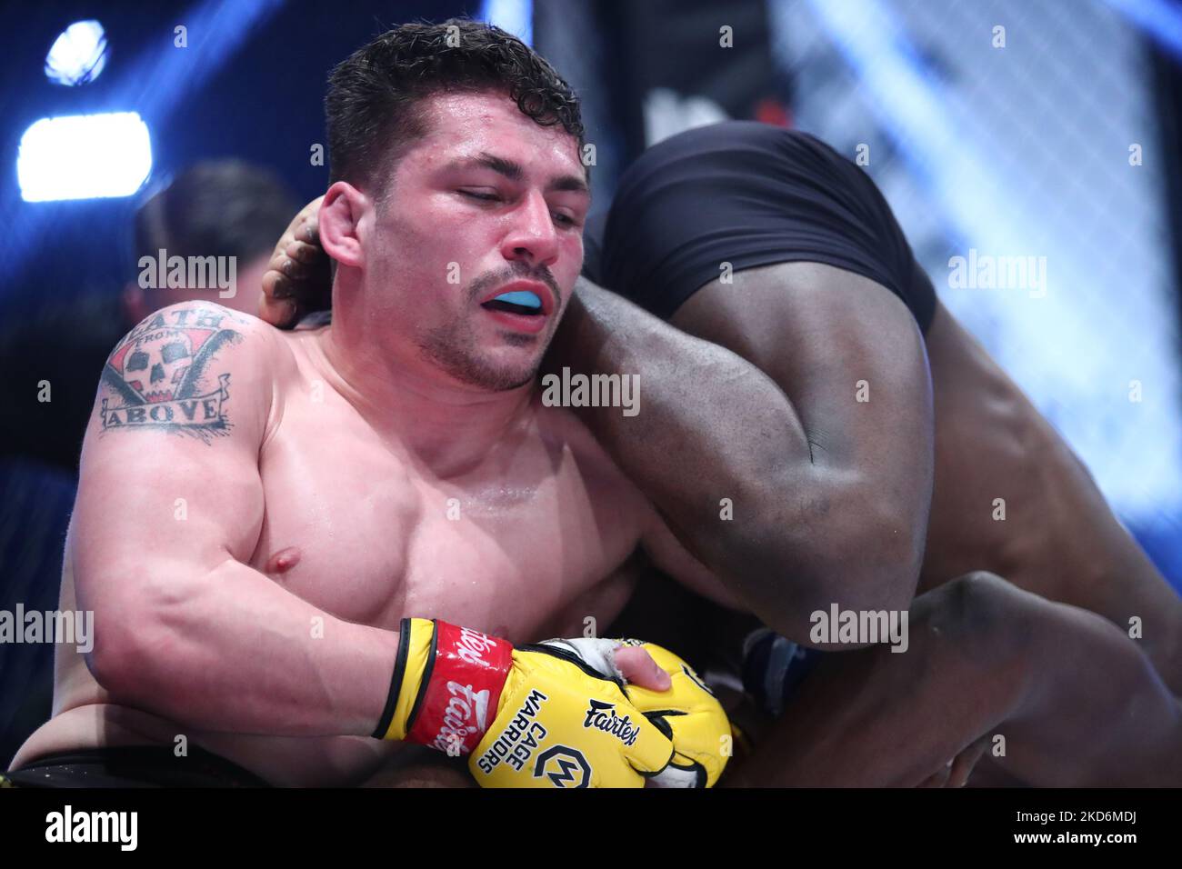 Liam Gittins grapples with Edward Walls during their bantamweight bout ...