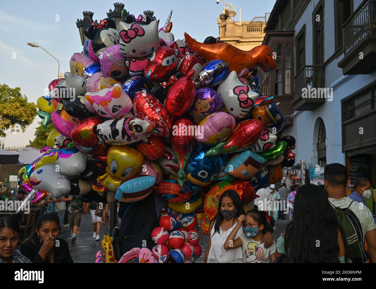 Balloon vendor in the Alameda Chabuca Granda, a busy wide viewpoint and ...