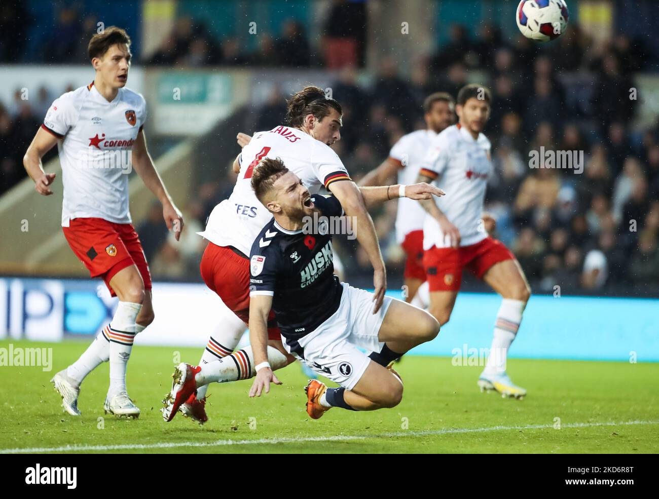 Millwall's Tom Bradshaw tussles with Hull City's Jacob Greaves during ...
