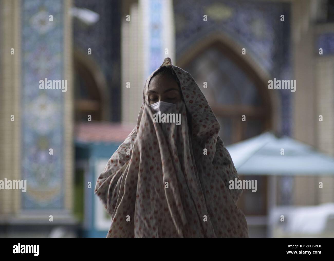 An Iranian veiled woman in white chador (Islamic dressing code) wearing ...