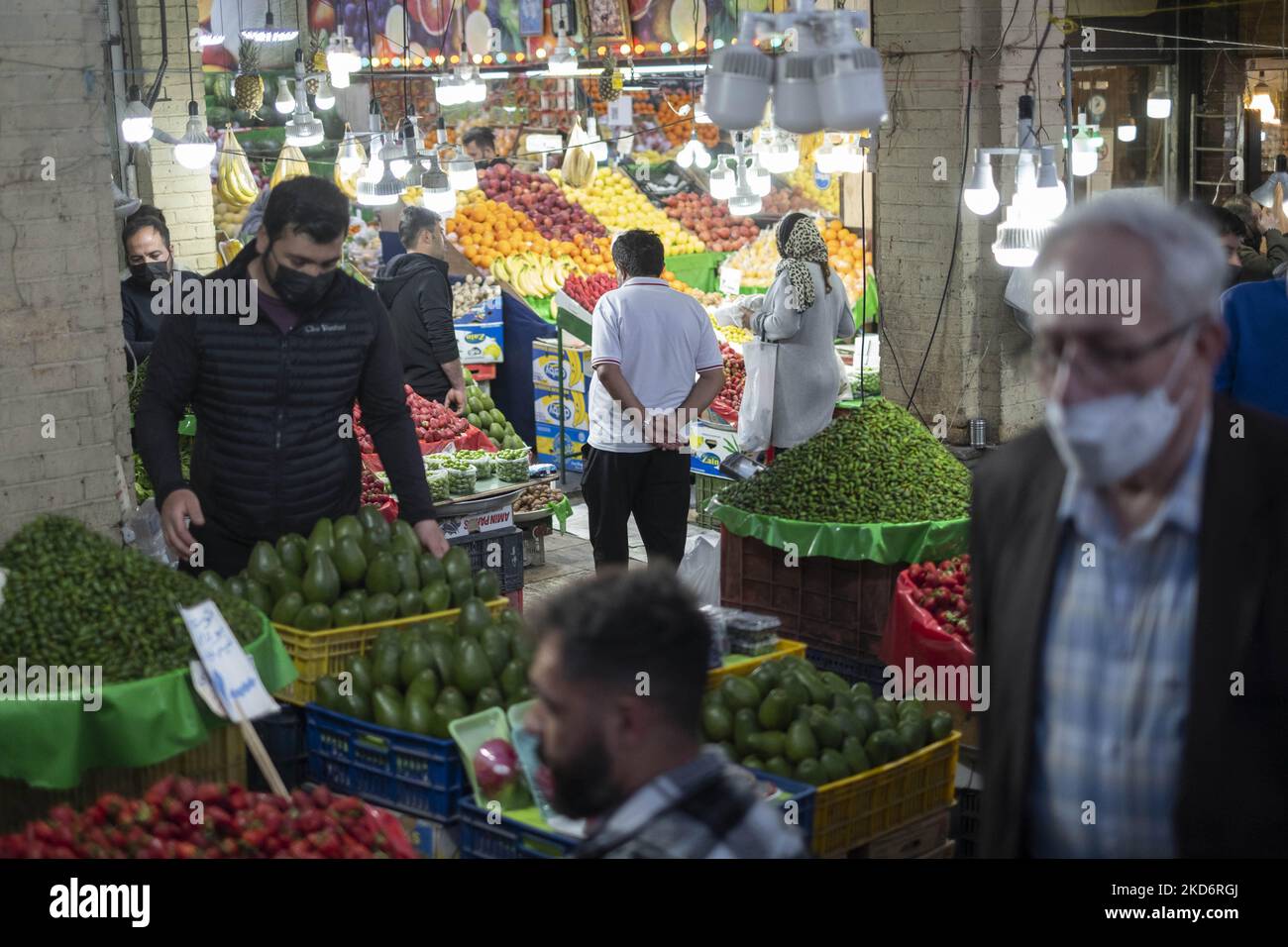An Iranian man looks at fruits and vegetables while shopping at the ...