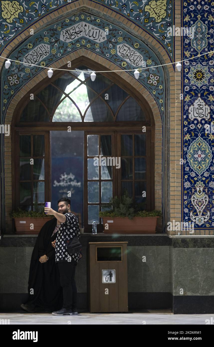 An Iranian couple take a selfie with an smartphone in a holy shrine in ...