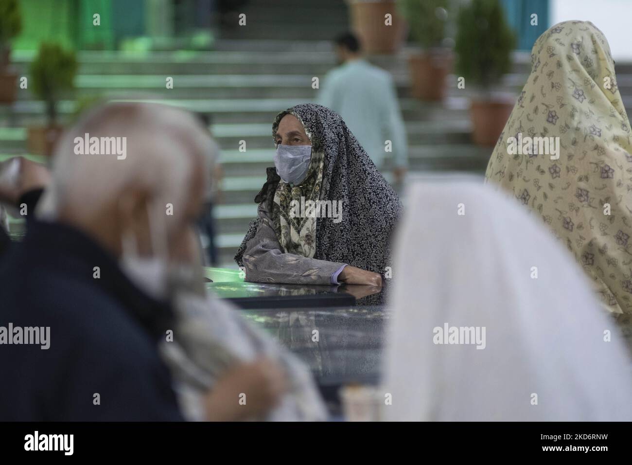 An Iranian veiled woman in white chador (Islamic dressing code) wearing ...