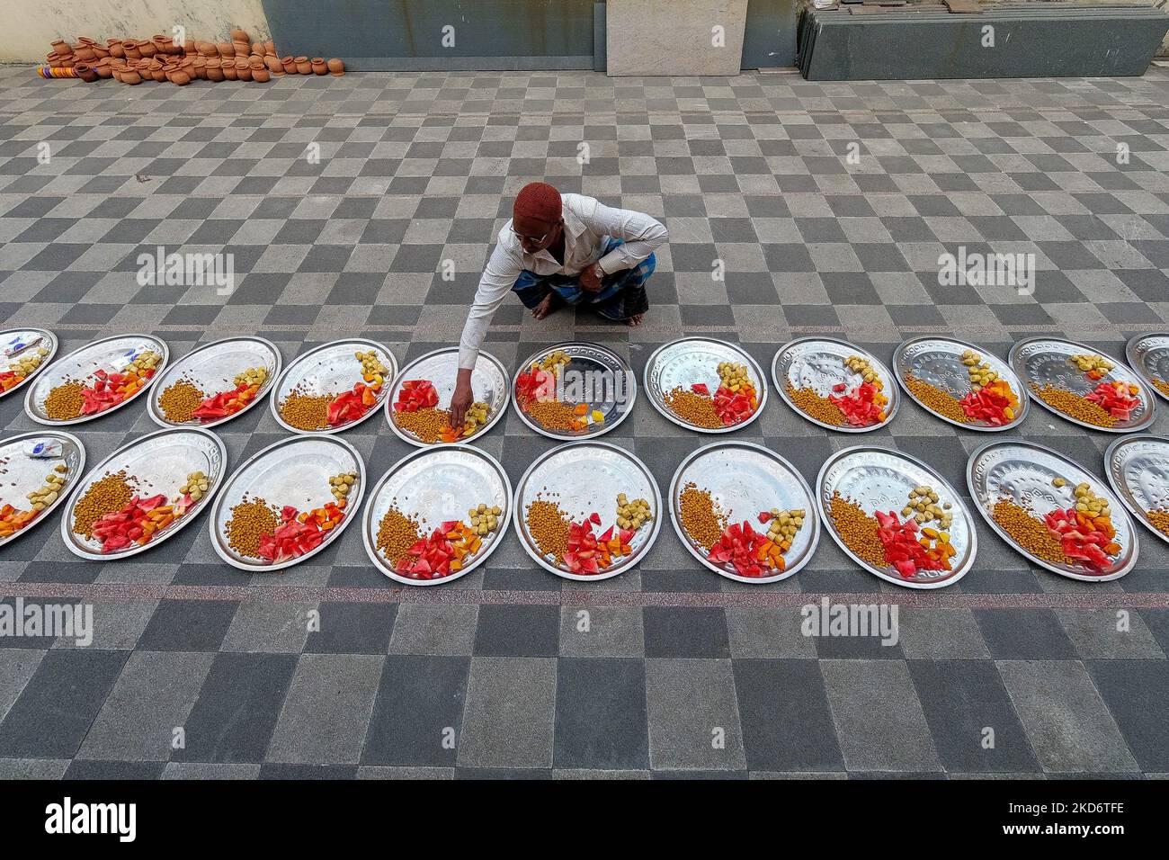 A man is seen preparing iftar meal to break the fast on the second day ...