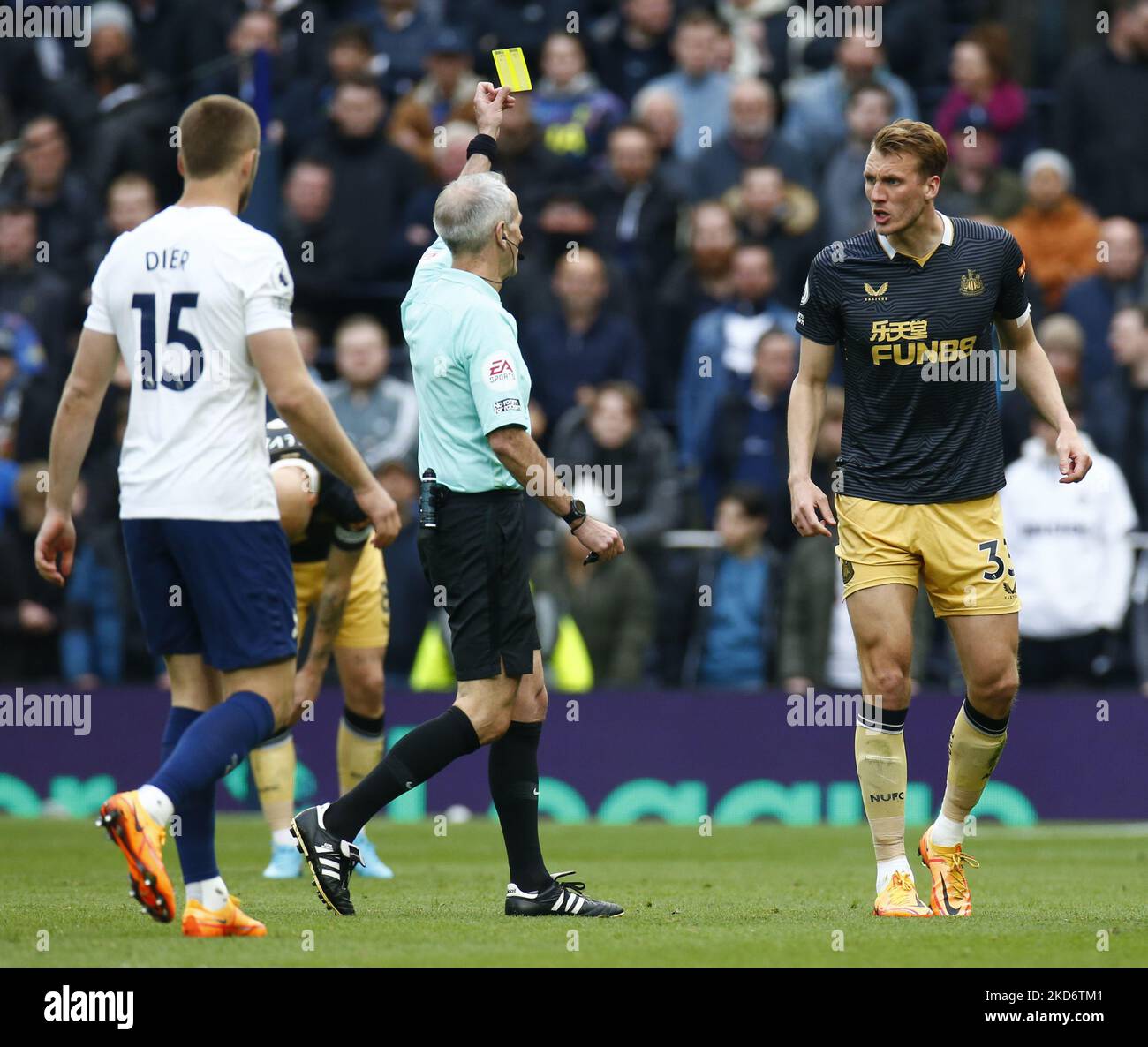 Newcastle United's Dan Burn gets a yellow card during Premier League ...