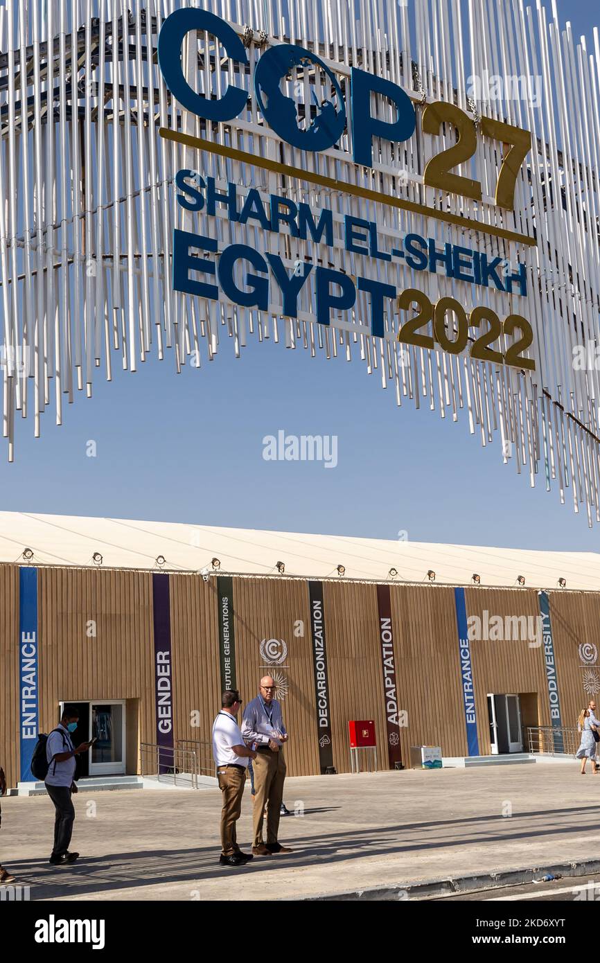 People gather at the main entrance as first participants arrive at the ...